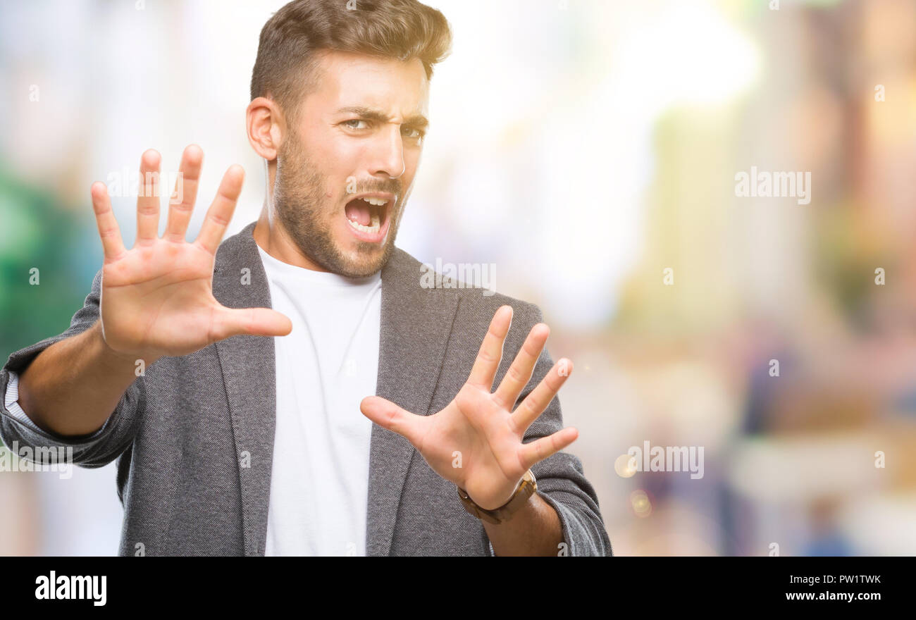 Young handsome business man over isolated background afraid and ...