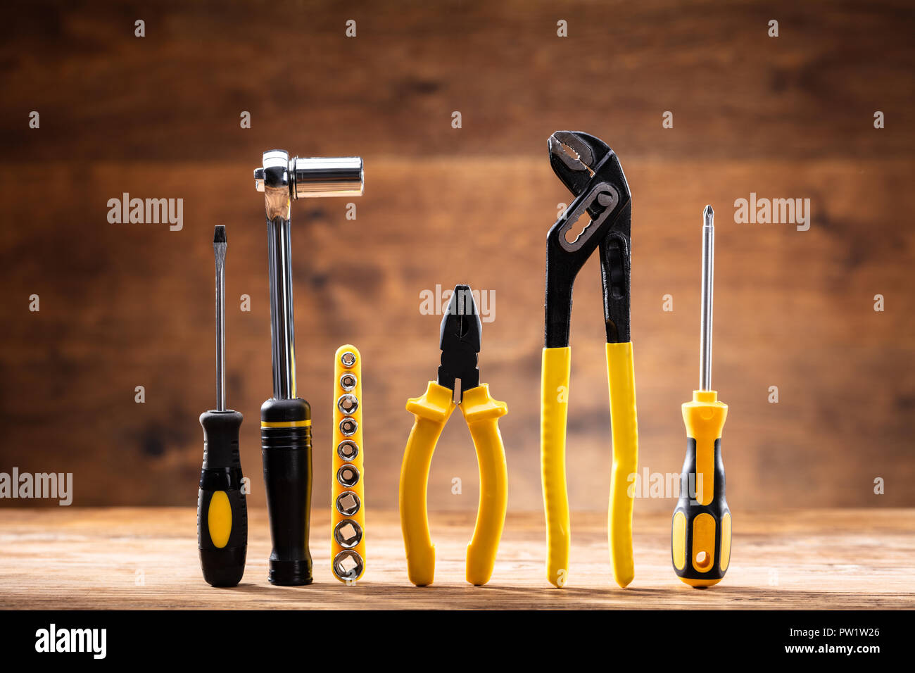 Row Of Various Worktools On Wooden Desk Stock Photo - Alamy