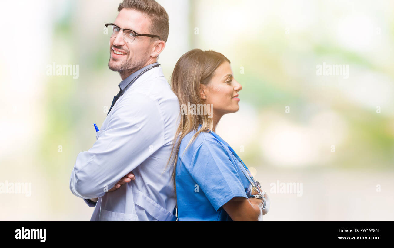 Young couple of doctor and surgeon over isolated background happy face ...
