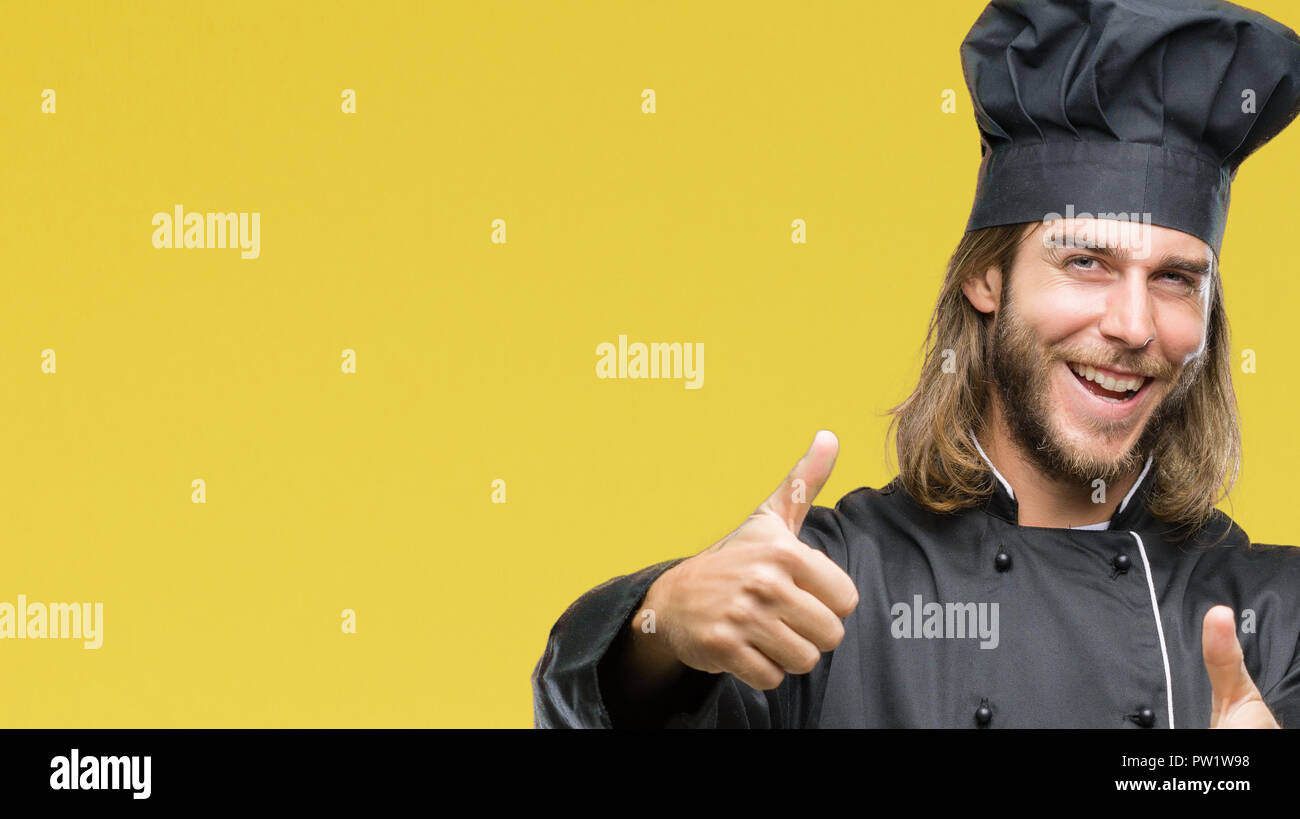 Young handsome cook man with long hair over isolated background ...