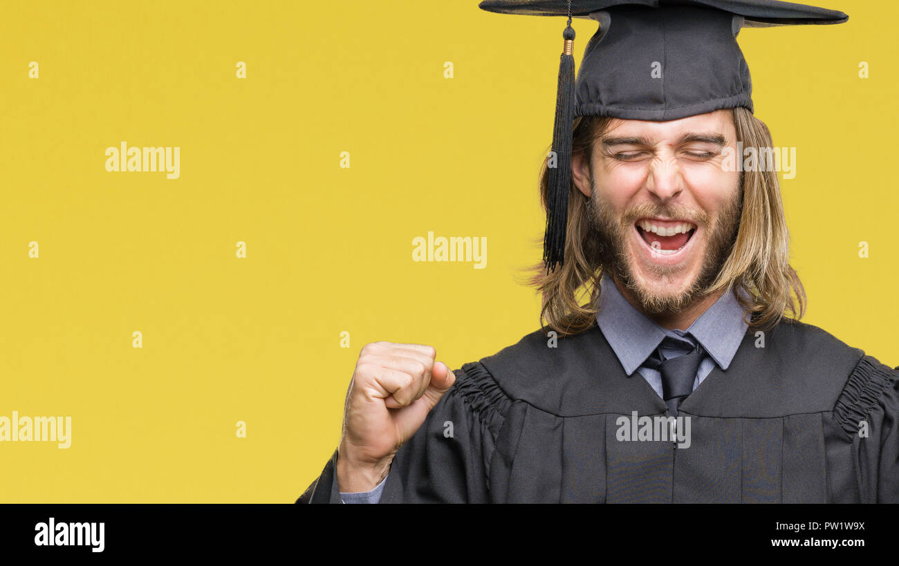 Young handsome graduated man with long hair over isolated background ...