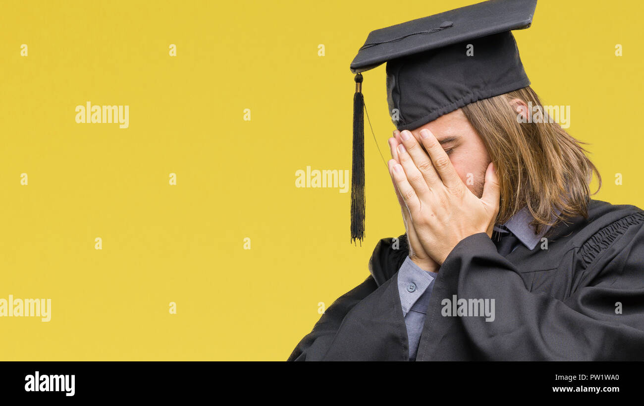 Young handsome graduated man with long hair over isolated background ...