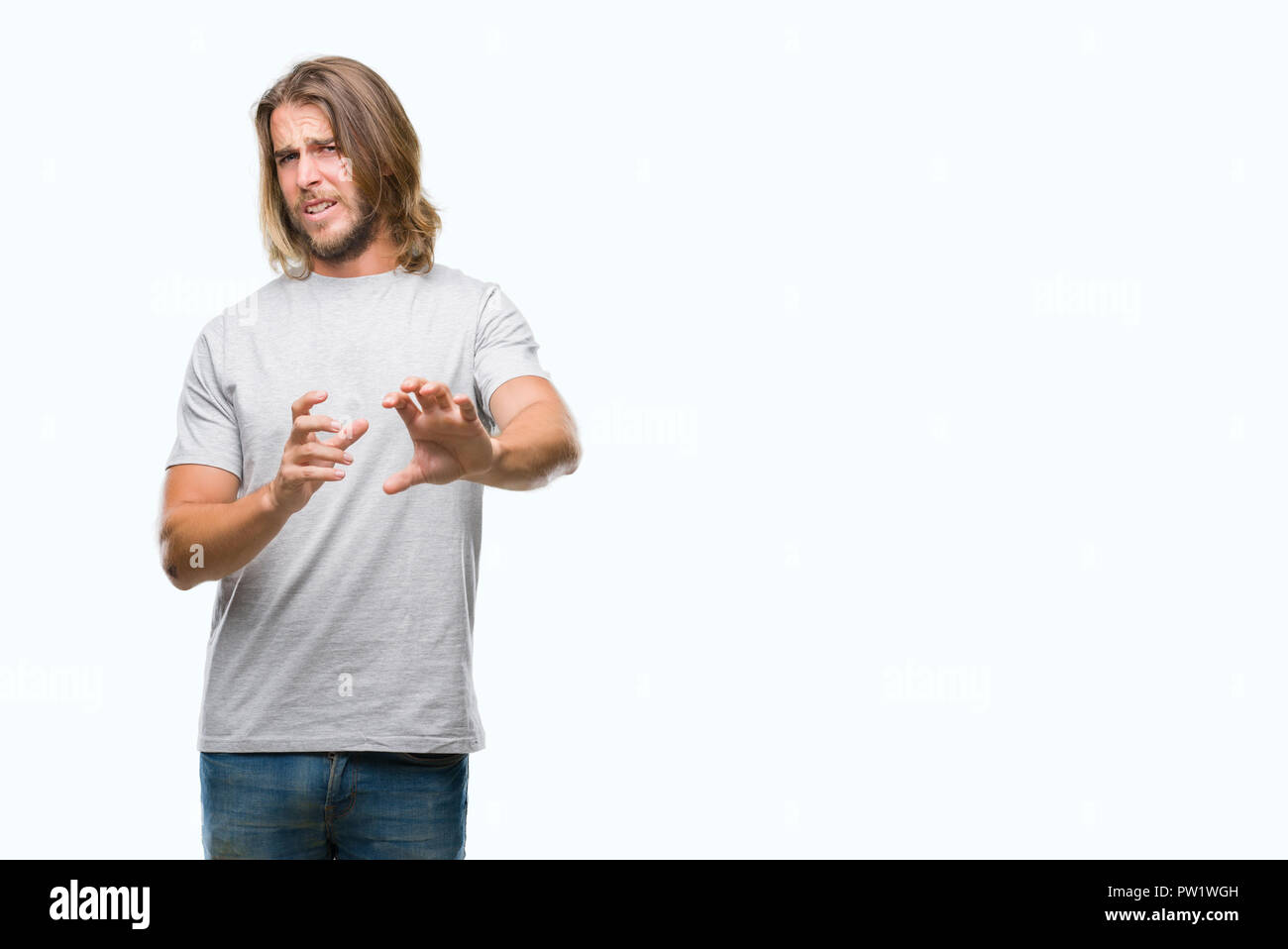 Young handsome man with long hair over isolated background disgusted ...