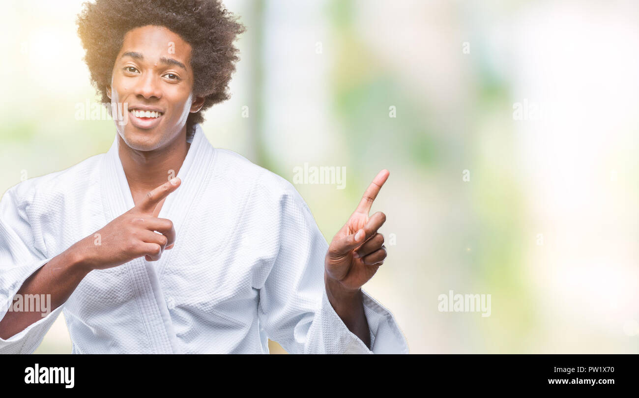Afro american man wearing karate kimono over isolated background ...