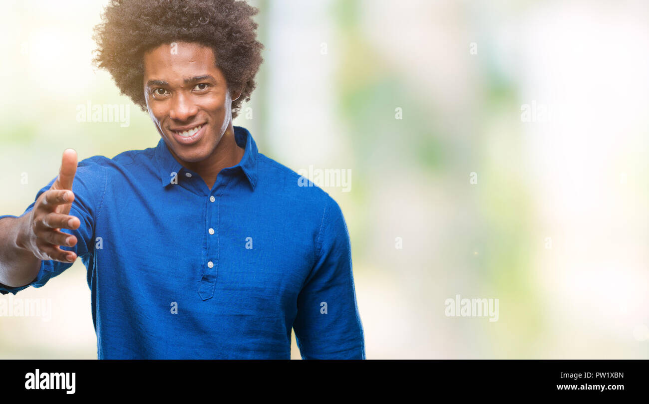 Afro american man over isolated background smiling friendly offering ...