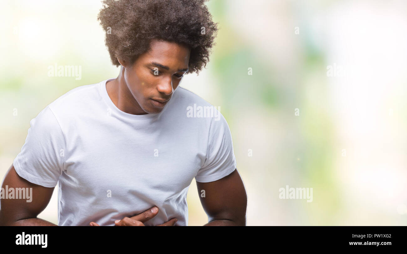 Afro american man over isolated background with hand on stomach because ...