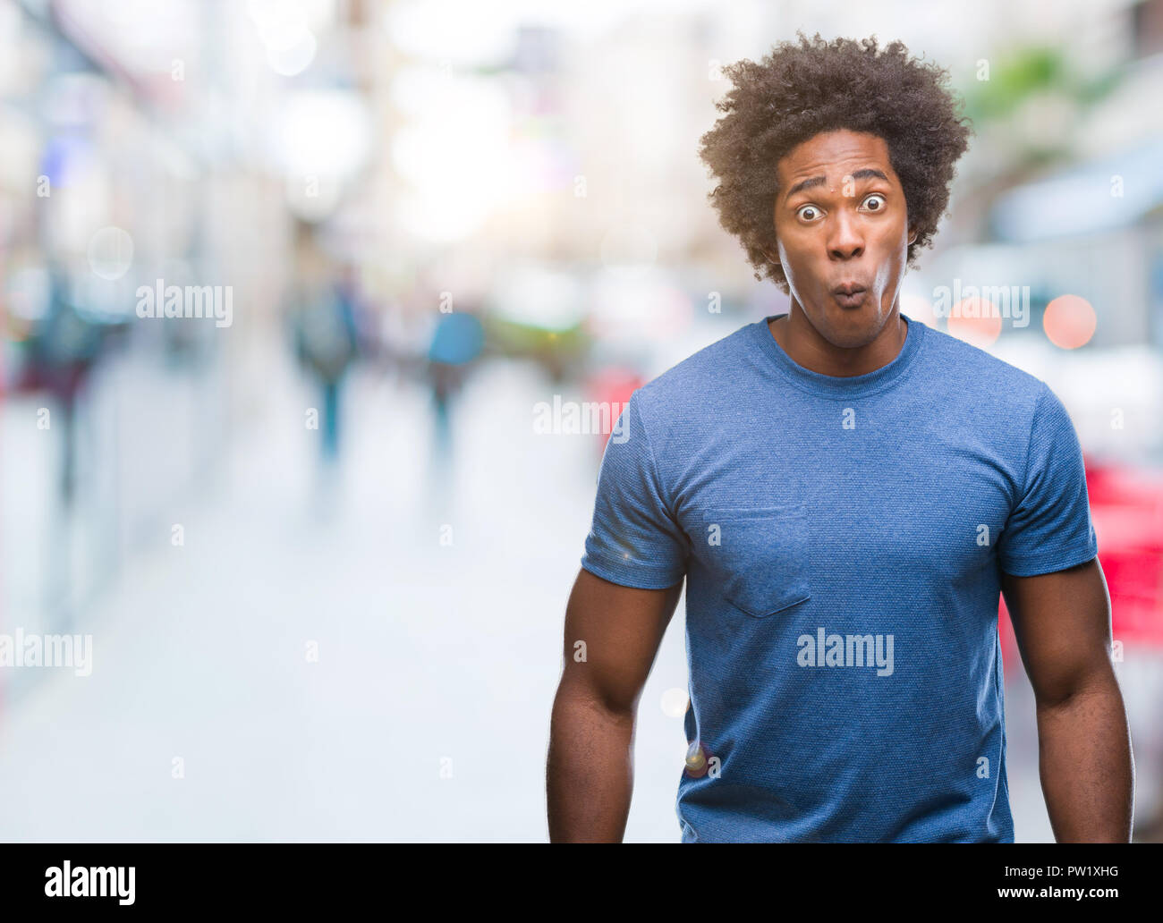 Afro american man over isolated background making fish face with lips ...