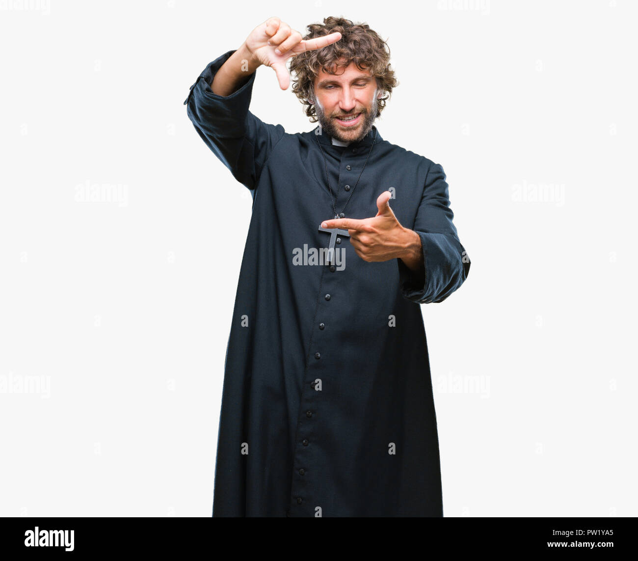 Handsome hispanic catholic priest man over isolated background smiling ...