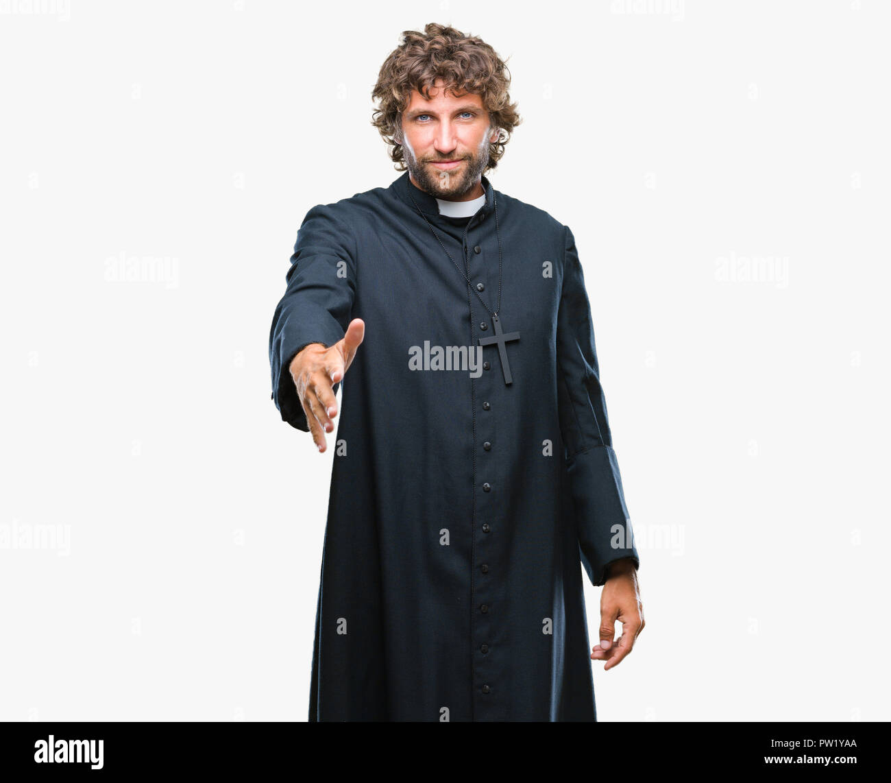 Handsome hispanic catholic priest man over isolated background smiling ...