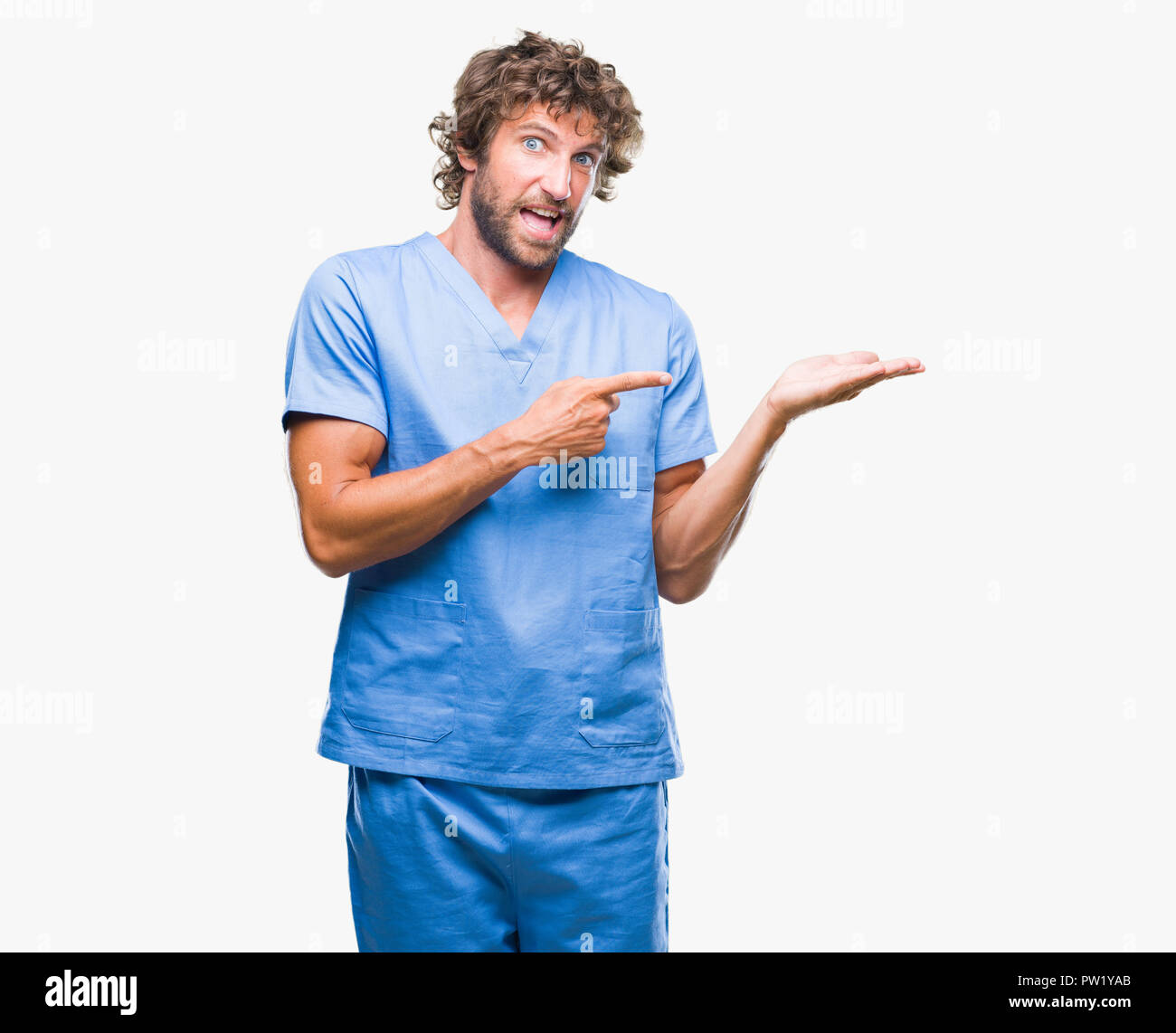 Handsome hispanic surgeon doctor man over isolated background amazed ...