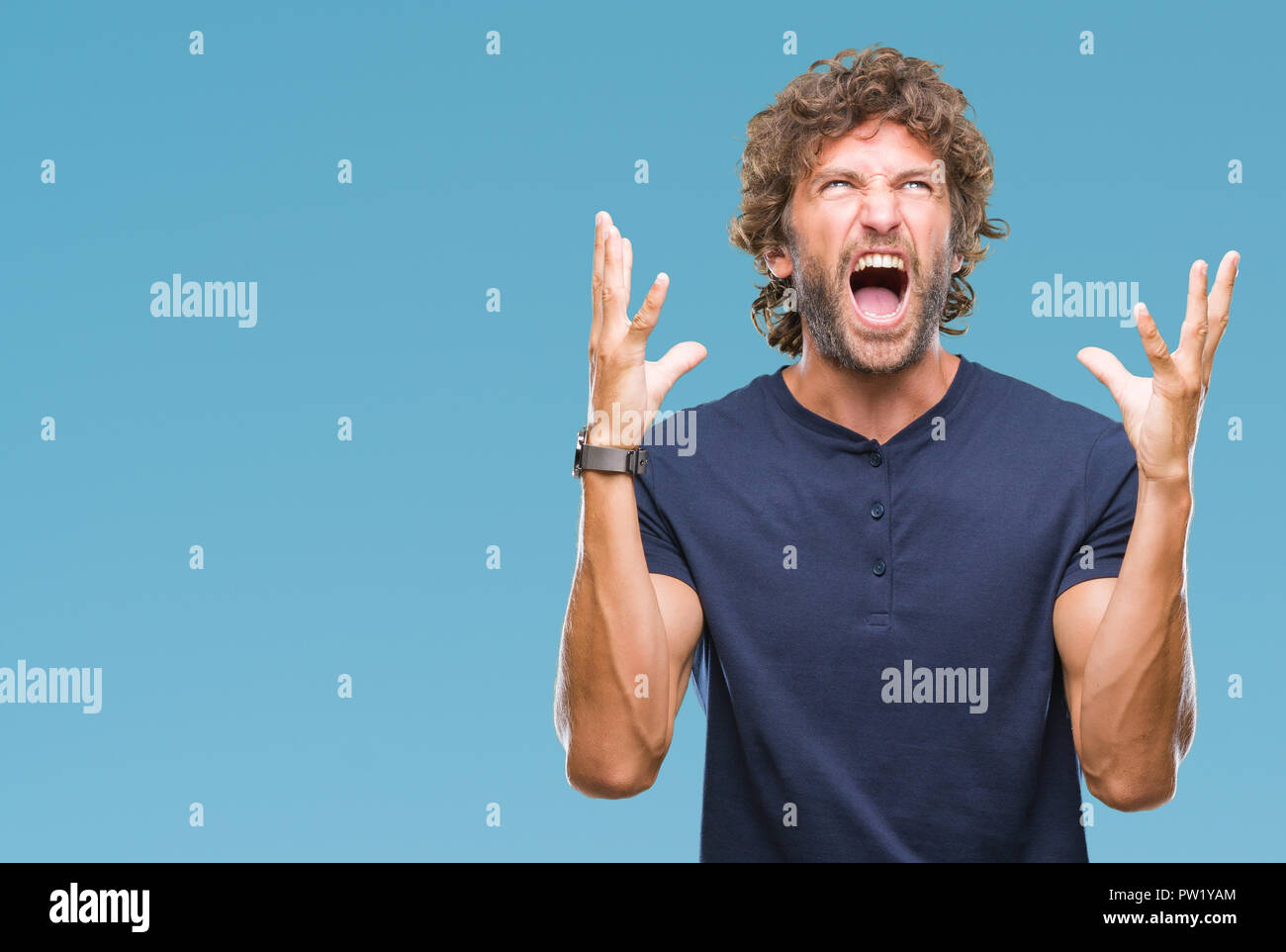 Handsome hispanic model man over isolated background crazy and mad ...