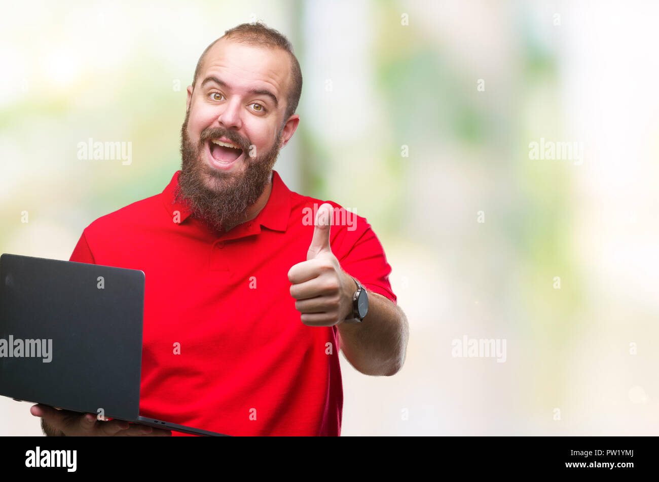 Young caucasian man using computer laptop over isolated background ...
