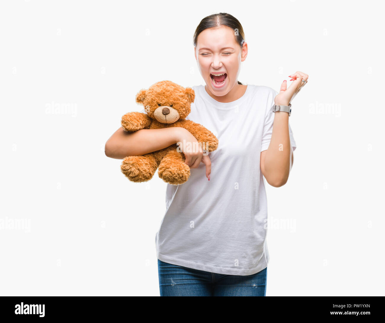 Young caucasian woman holding teddy bear over isolated background very ...