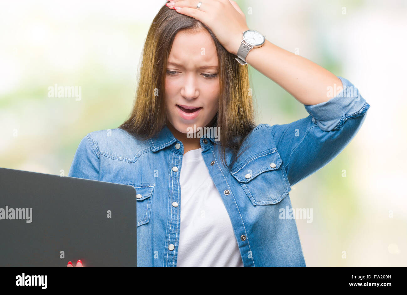 Young caucasian woman using laptop over isolated background stressed ...