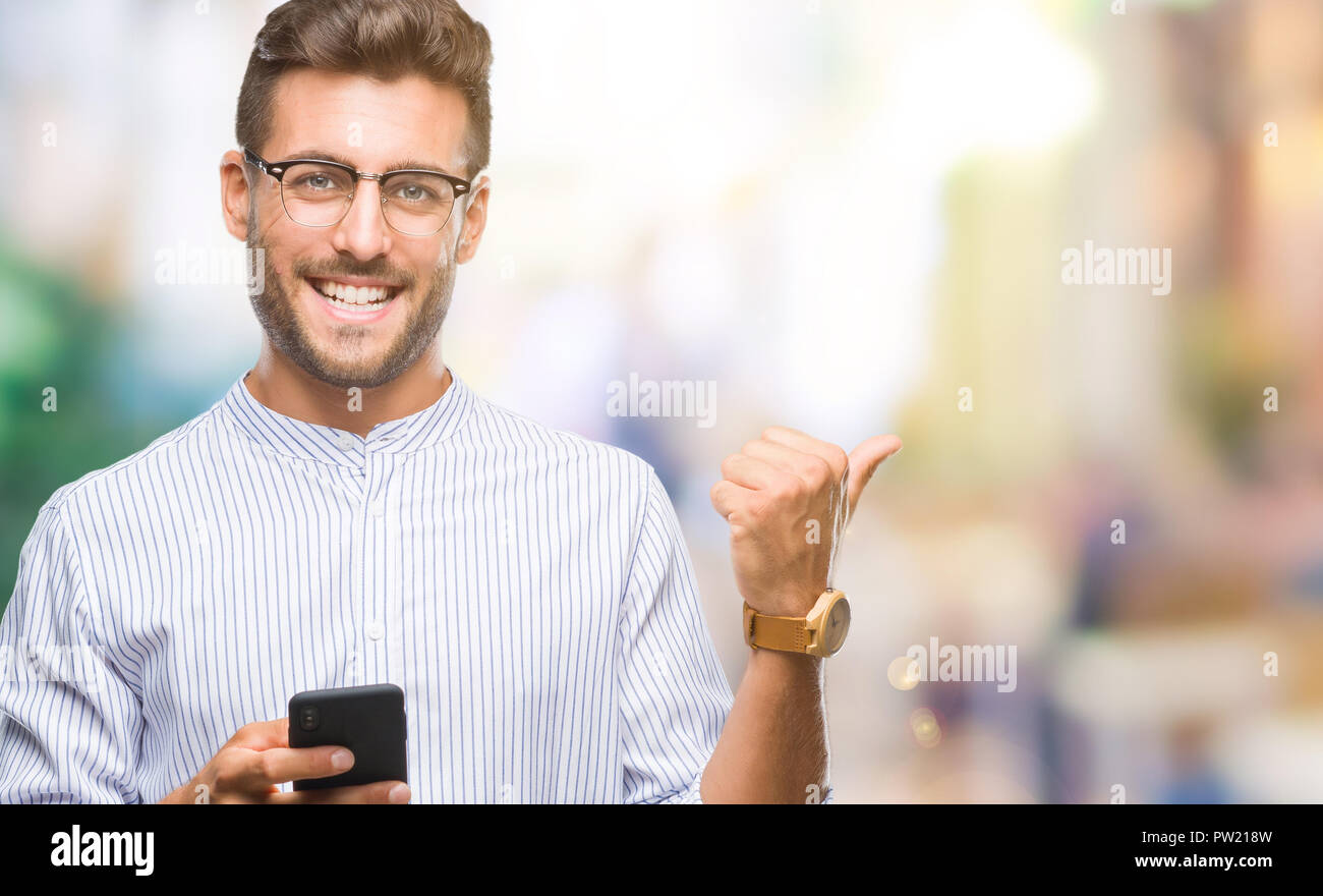 Young handsome man texting using smartphone over isolated background ...