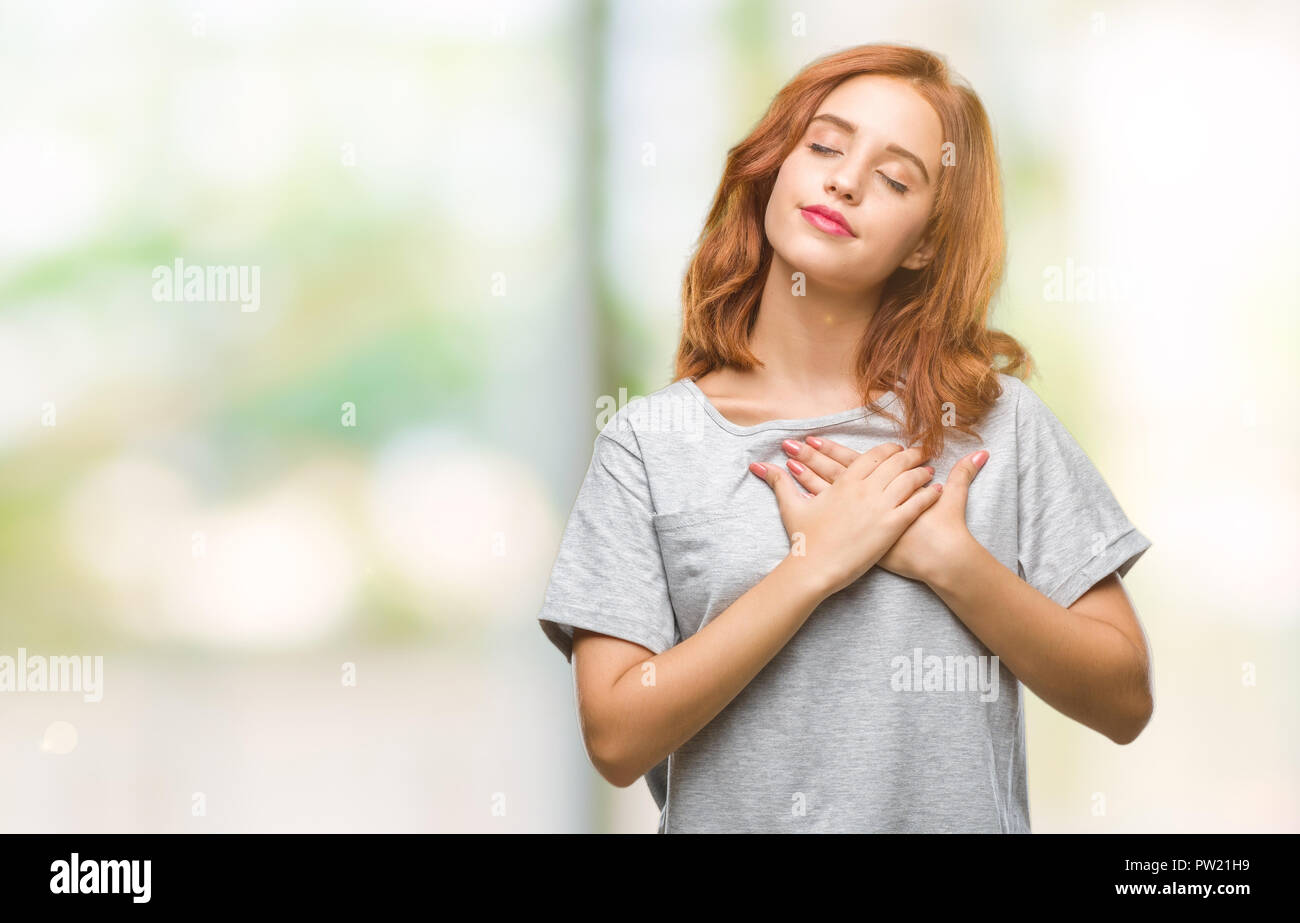 Young beautiful woman over isolated background smiling with hands on ...