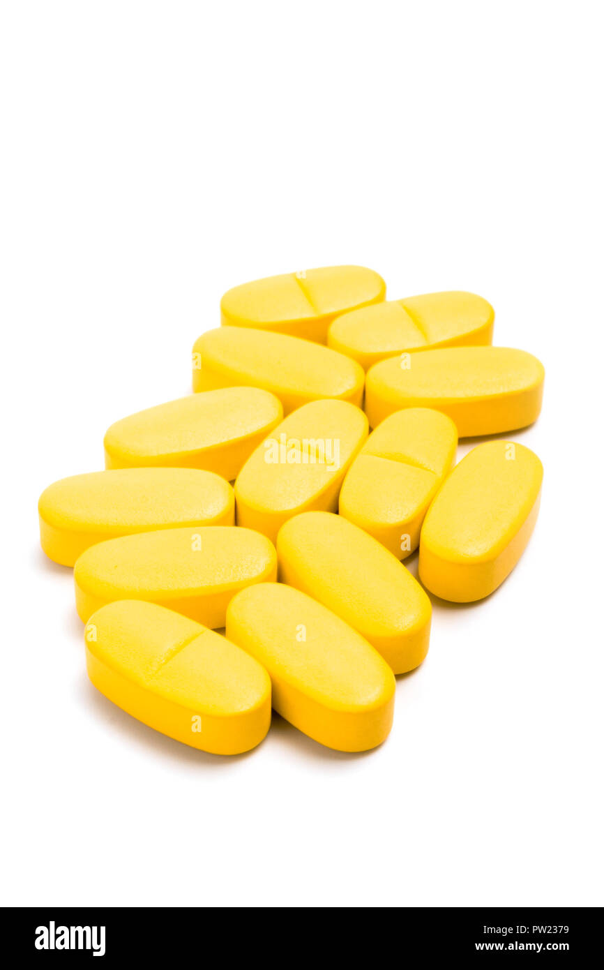 yellow vitamin pills isolated on white beckground Stock Photo - Alamy