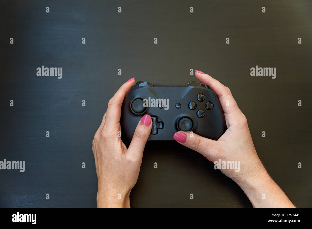 Woman hand holding black joystick gamepad, game console on black ...