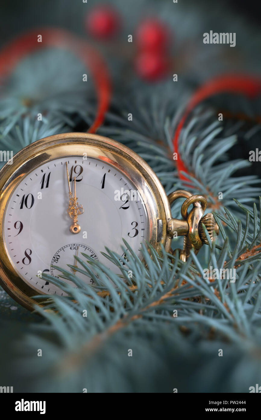 Vintage pocket watch showing five to twelve on gray rustic background ...