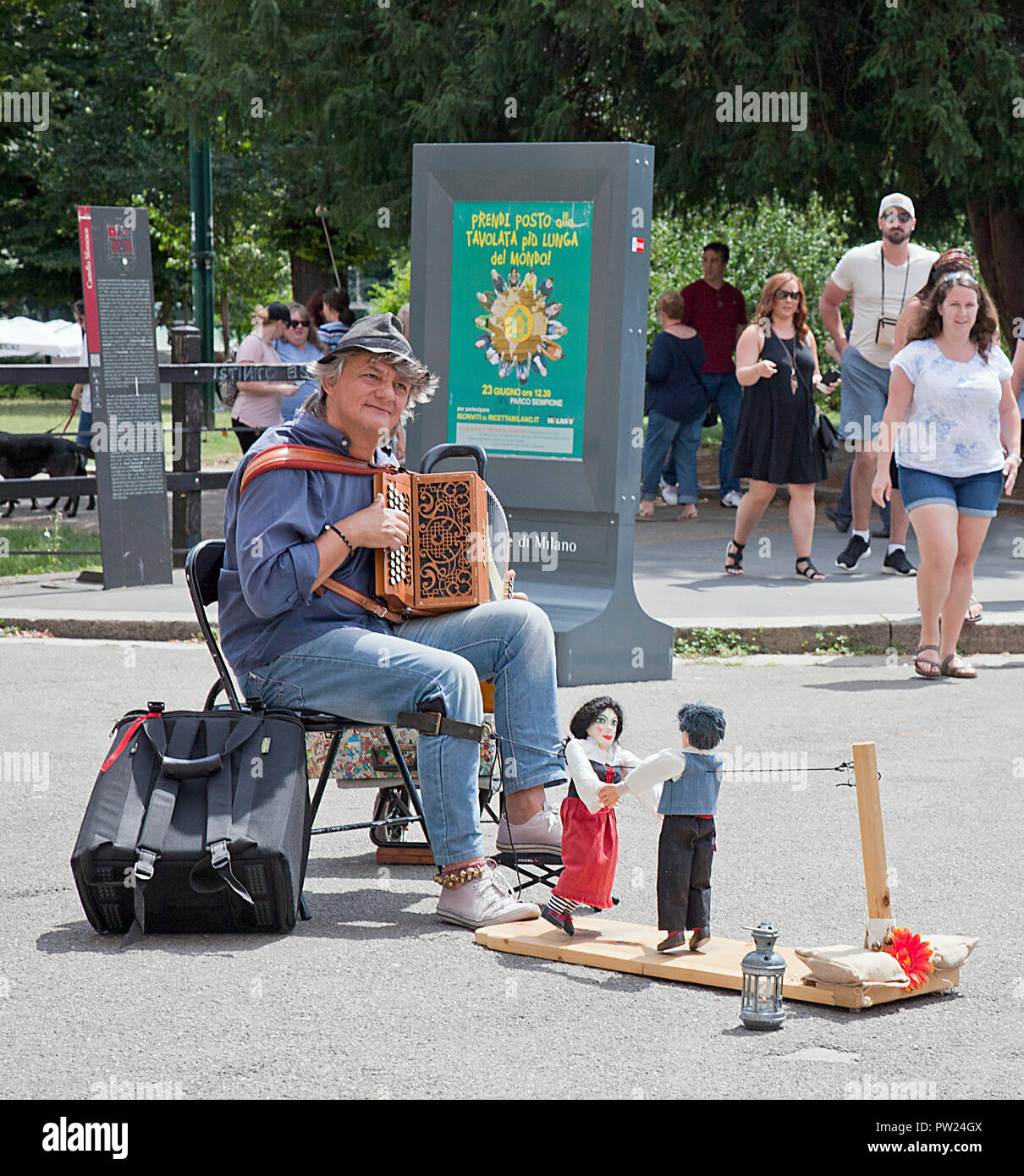 Busker with music box and puppets. Jig dolls, aka stick puppets, dance ...