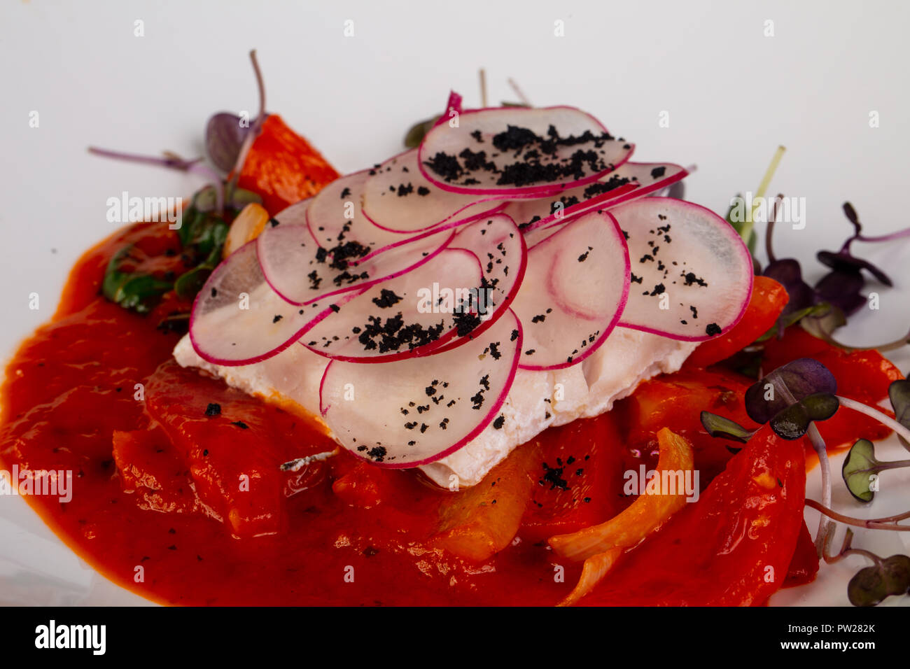 Steamed fish halibut with tomato sauce Stock Photo - Alamy