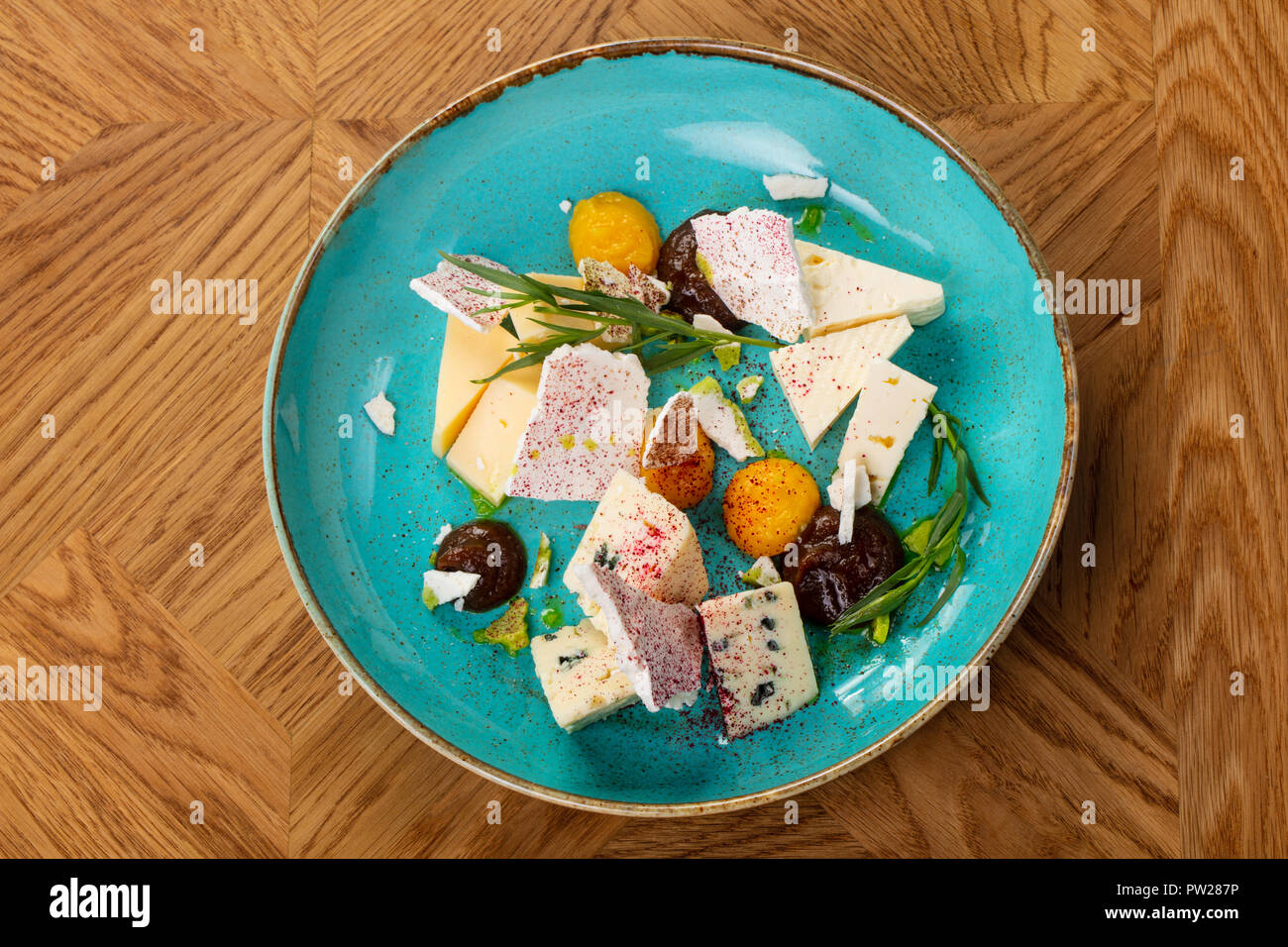 Cheeses plate mix served estragon Stock Photo - Alamy