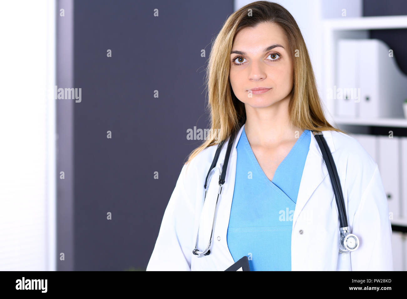 Woman doctor at work in hospital office. Portrait of female physician ...