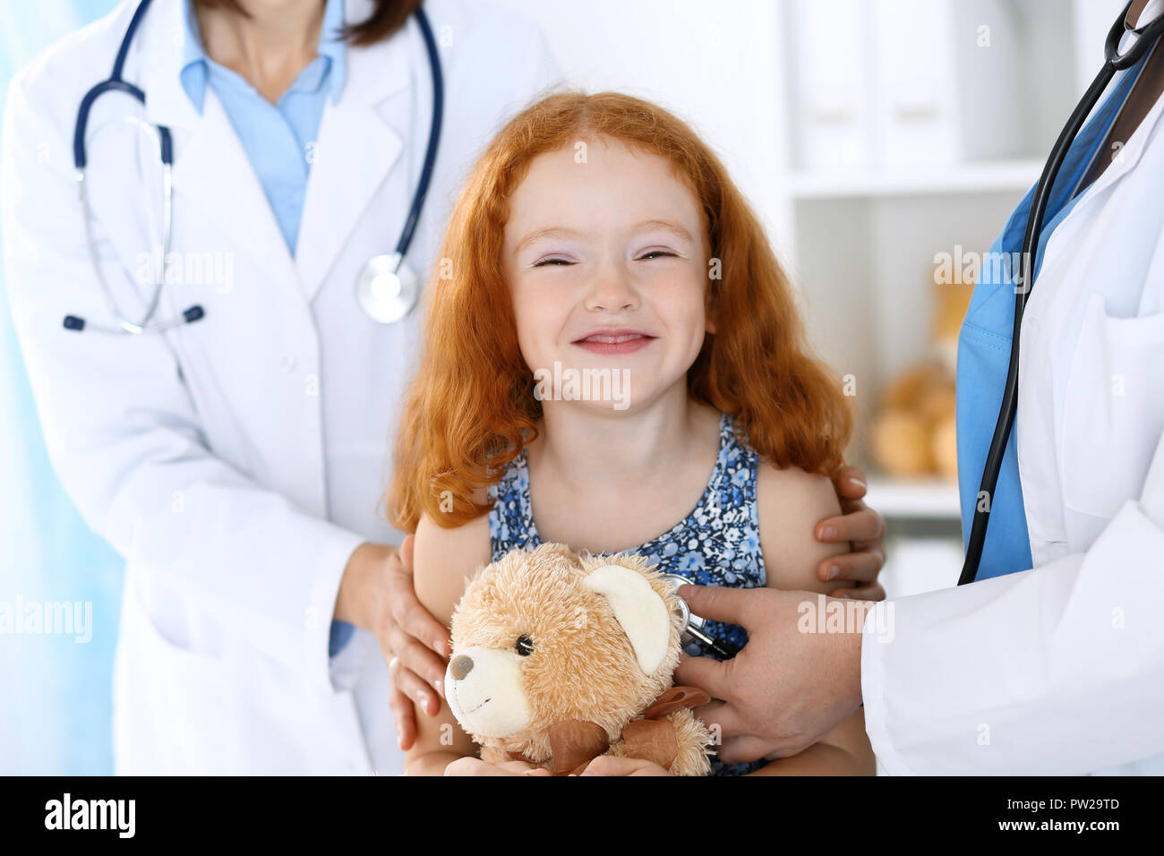 Doctor examining a little girl with stethoscope.Medicine and healthcare ...