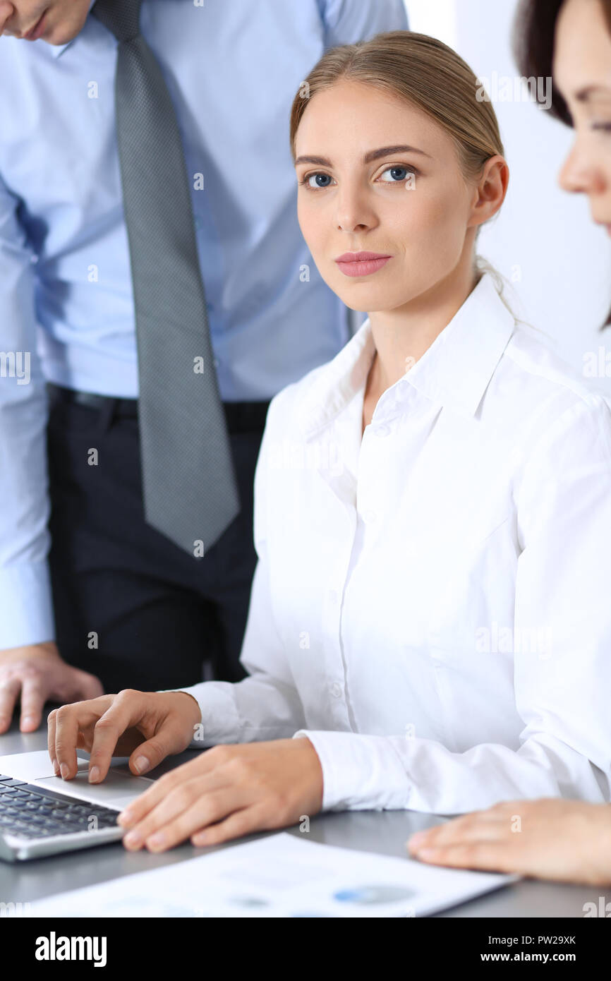 Group of business people using laptop computer in office. Meeting and ...