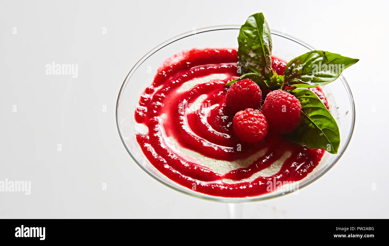 Delicious Italian dessert Panna Cotta with raspberry in small ...