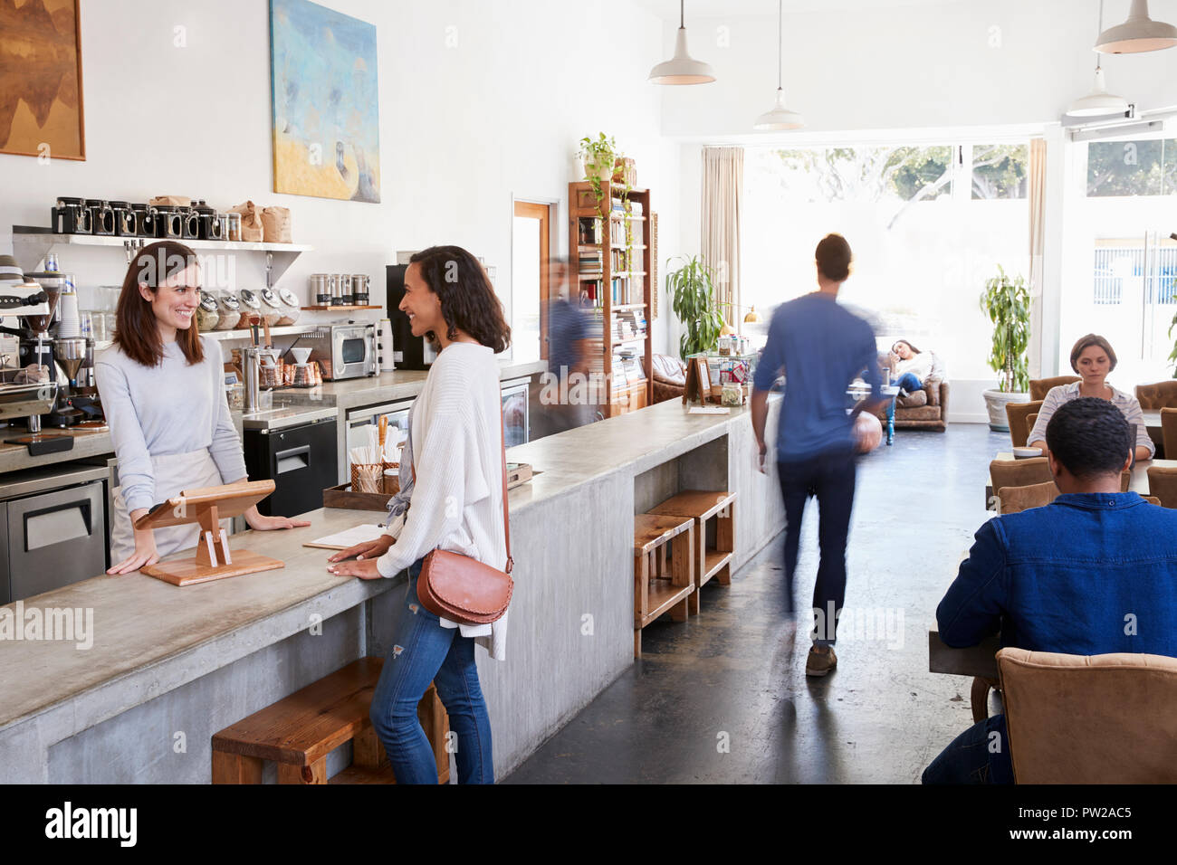 Female customer ordering at the counter in a coffee shop Stock Photo ...