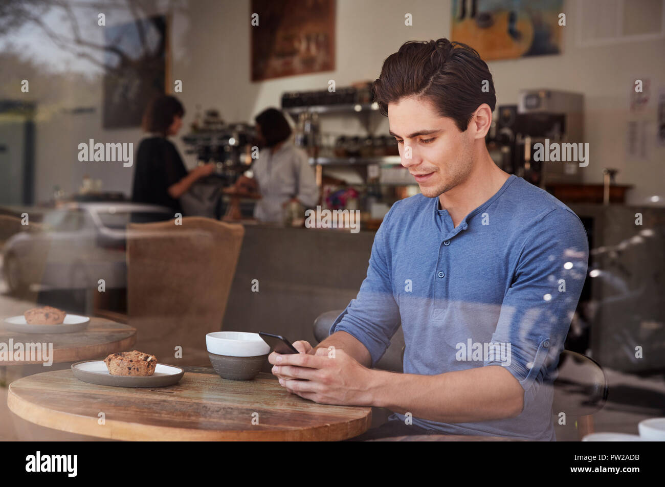 Customer in cafe using smartphone hi-res stock photography and images ...