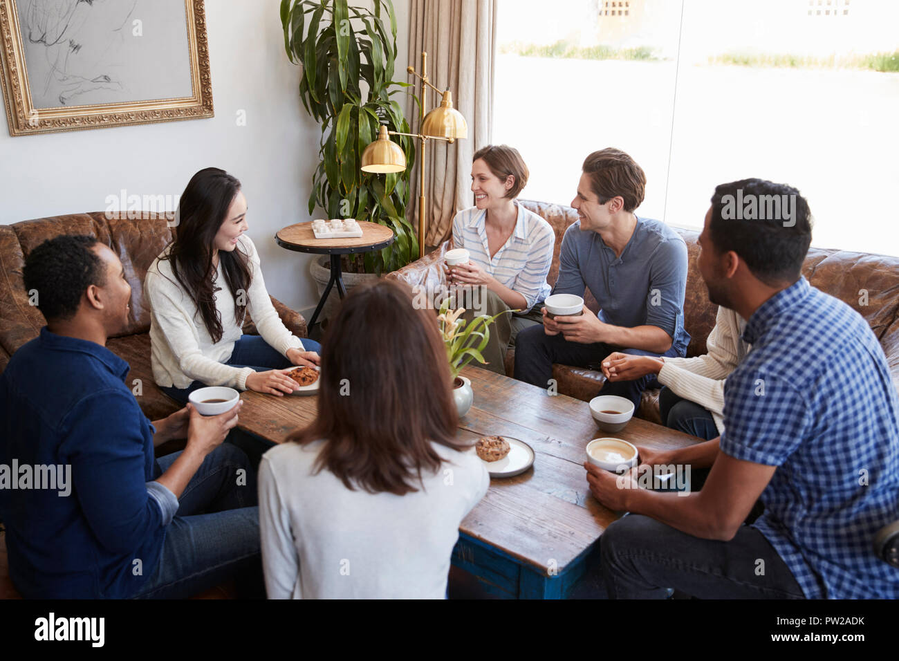 Group Of People Talking At Table