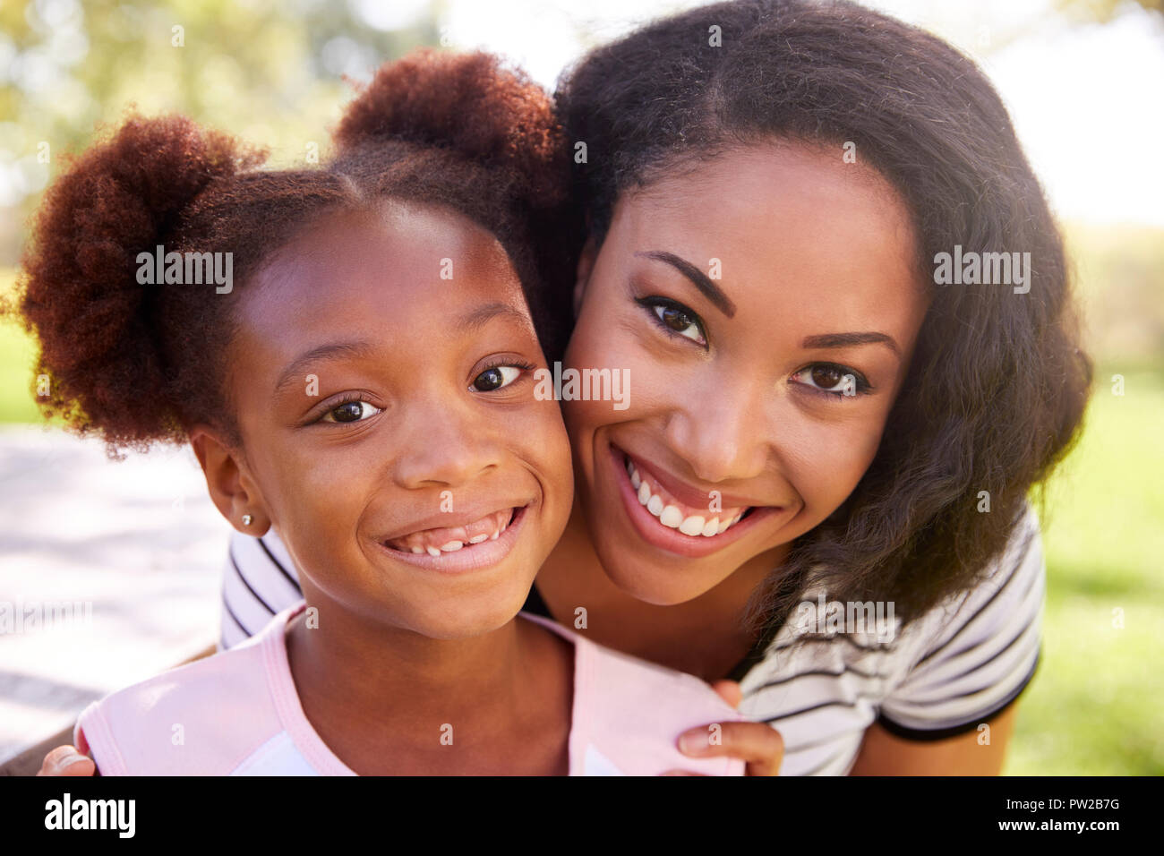 Portrait Of Smiling Mother With Daughter In Park Stock Photo - Alamy