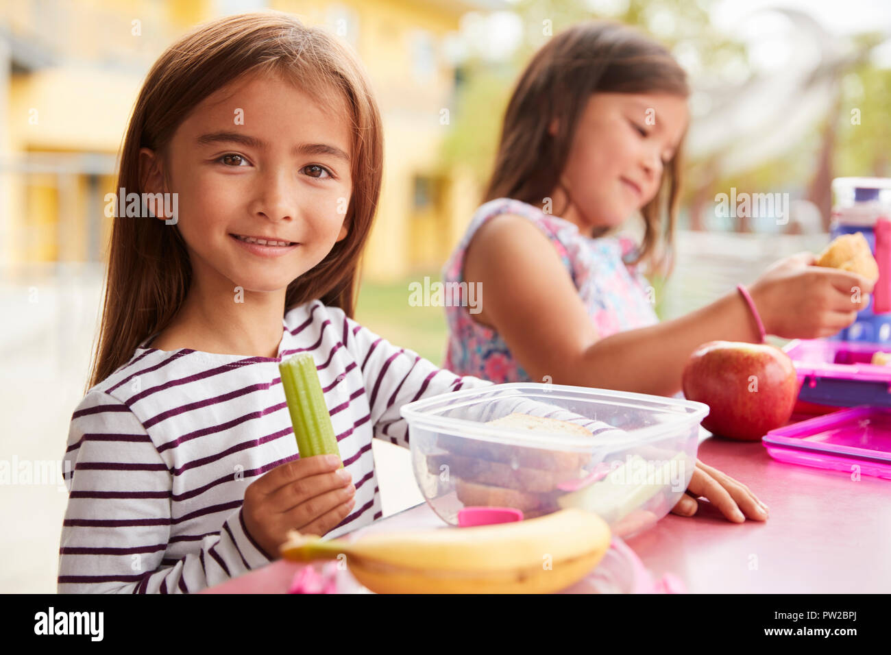 Two young girls eating packed lunches at school, close up Stock Photo ...