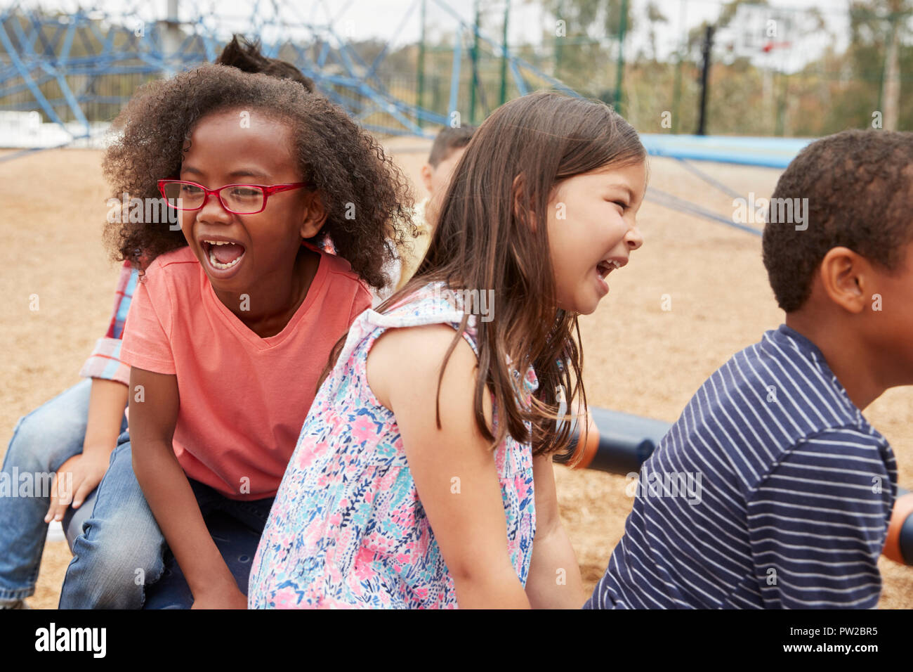Elementary school kids playing in playground, close up Stock Photo - Alamy