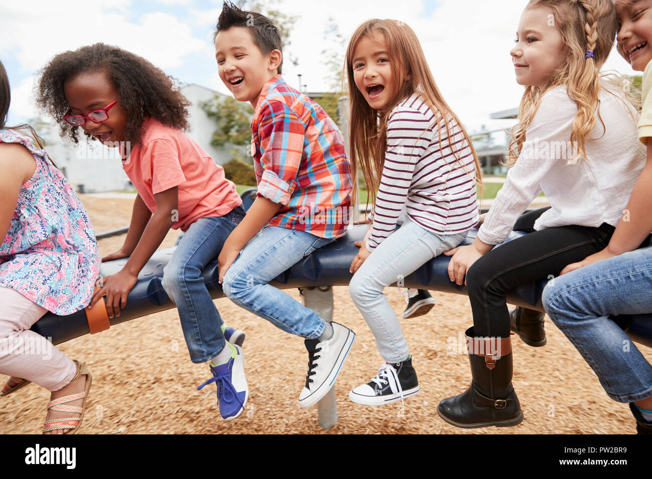Kids playing on a spinning carousel in their schoolyard Stock Photo - Alamy