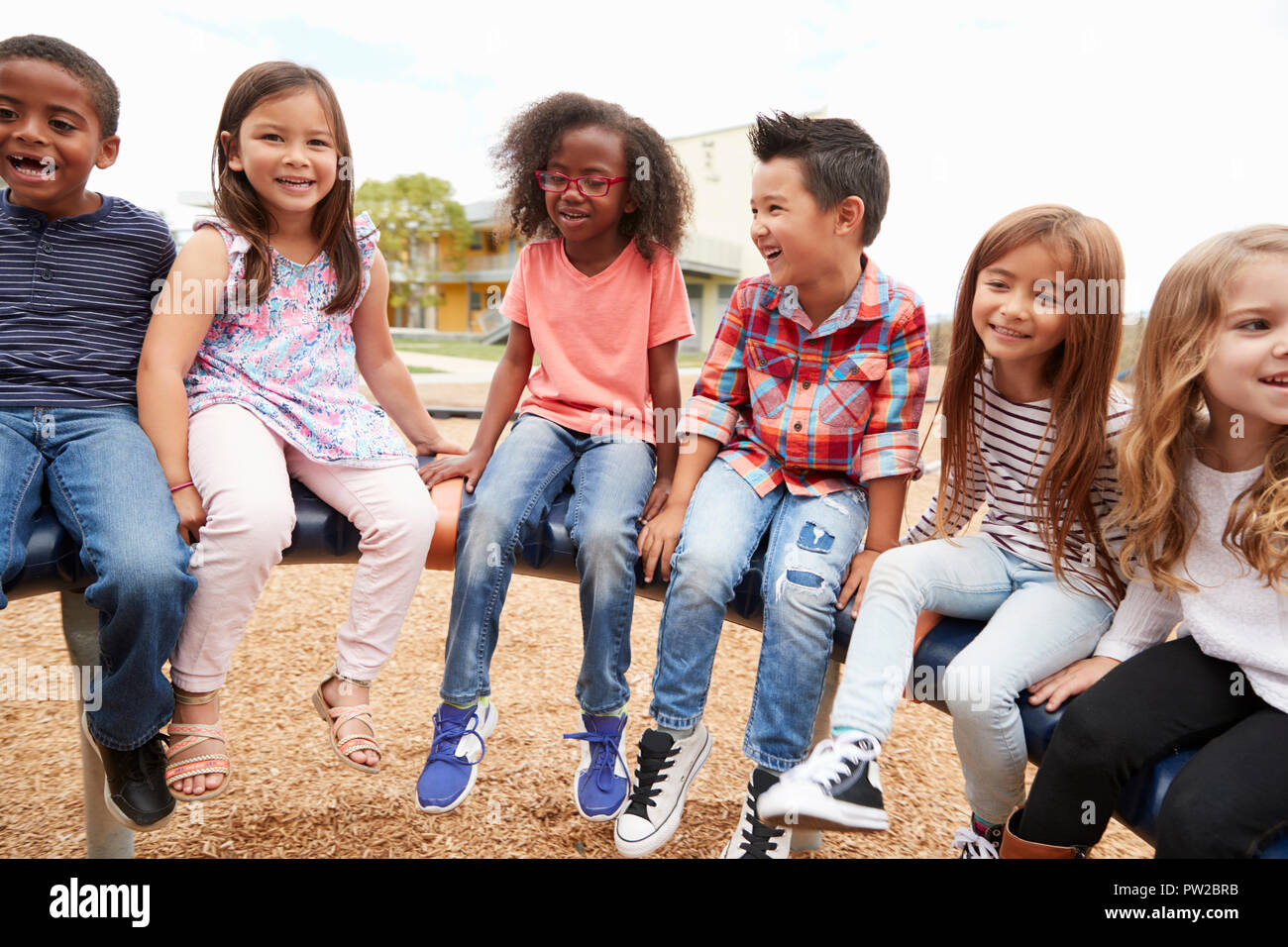 Elementary school friends sitting on a spinning carousel Stock Photo ...