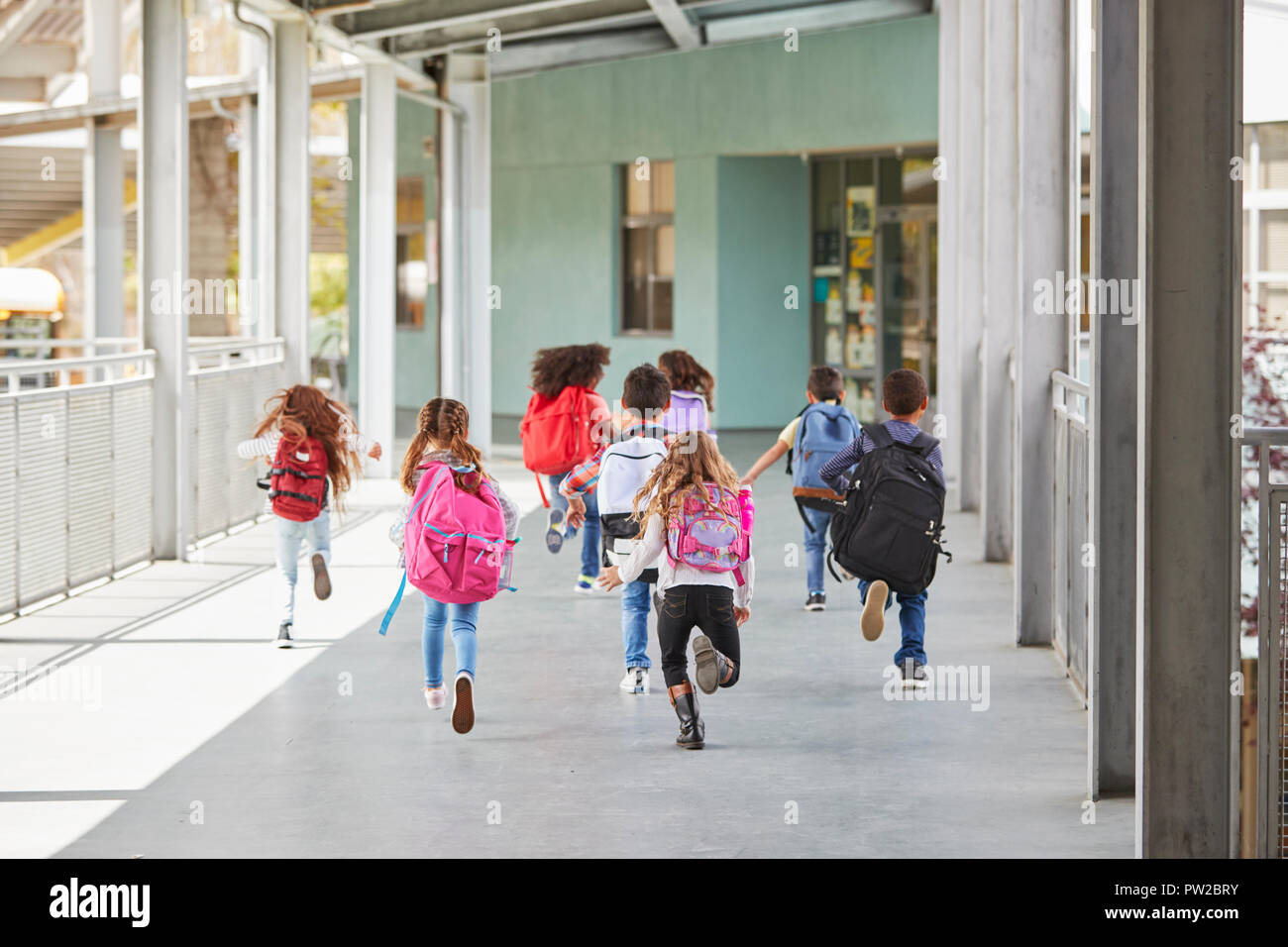 Elementary school kids run from camera in school corridor Stock Photo ...