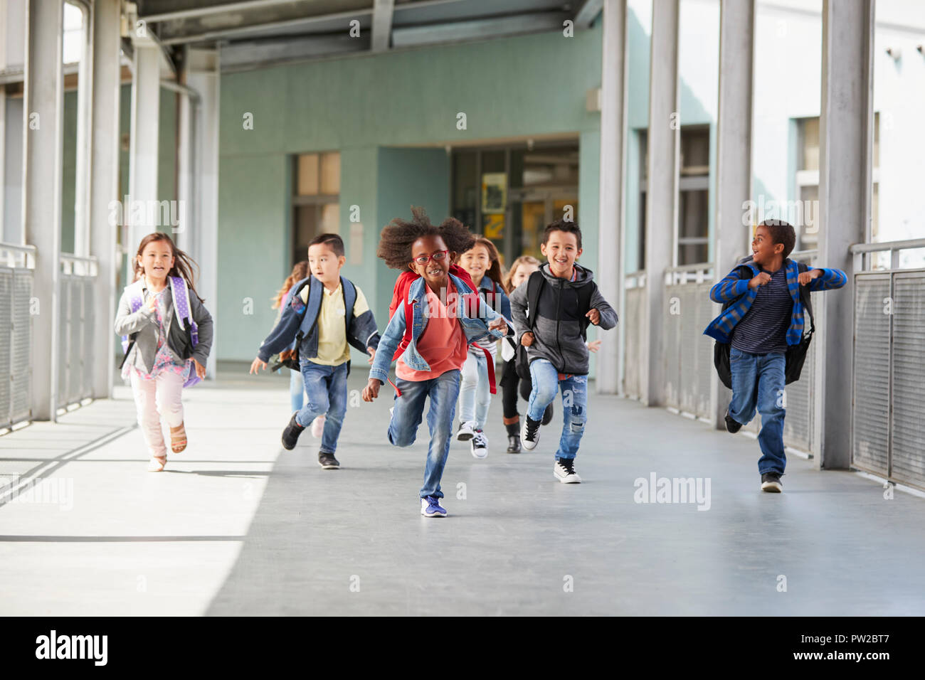 Elementary school kids running in a corridor in the school Stock Photo ...