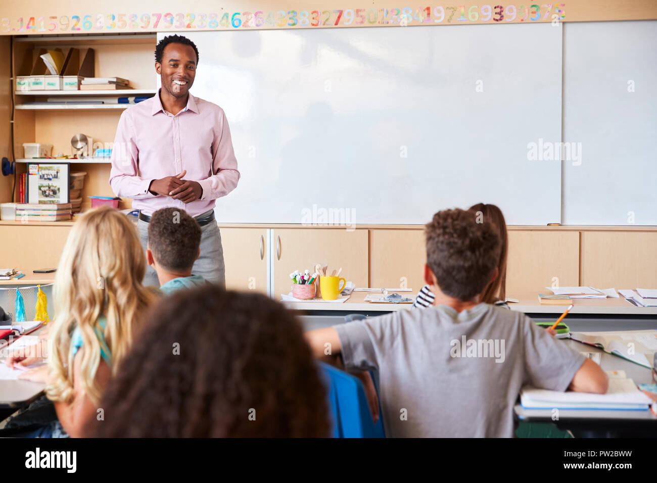 Teacher and kids in a lesson at an elementary school Stock Photo - Alamy