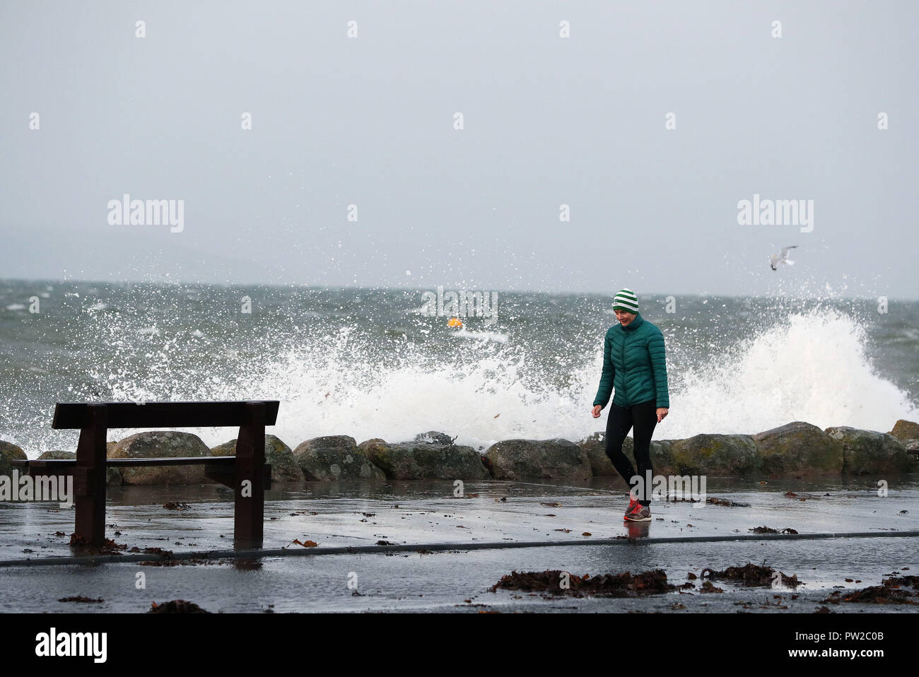 A woman walks on Salthill promenade, Co Galway, during Storm Callum ...