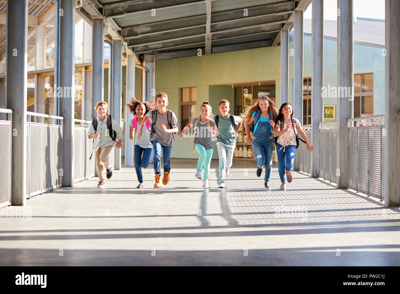 Group of elementary school kids running in a school corridor Stock ...
