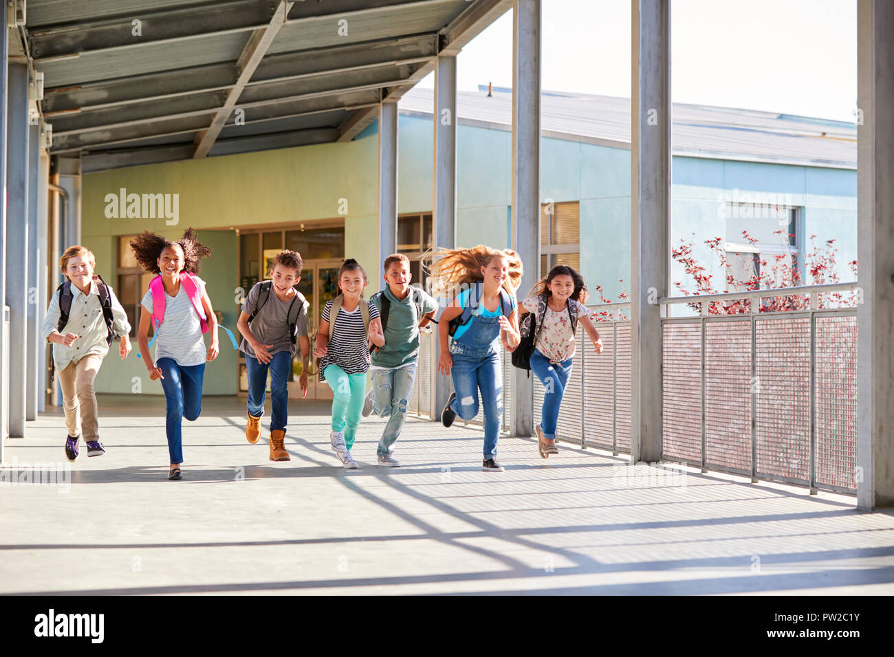 Happy running into school side view hi-res stock photography and images ...