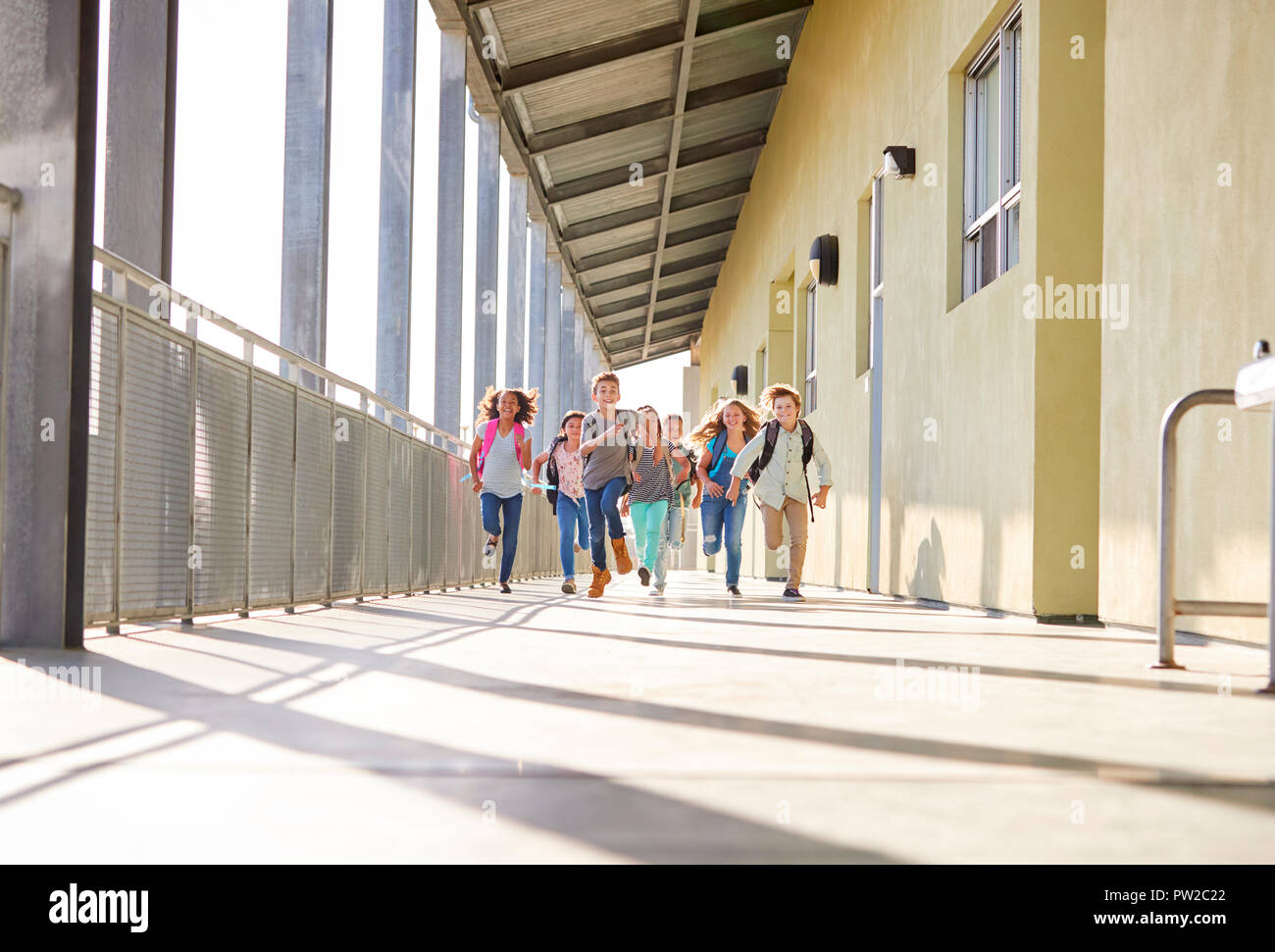 Group of elementary school kids running in a school corridor Stock ...