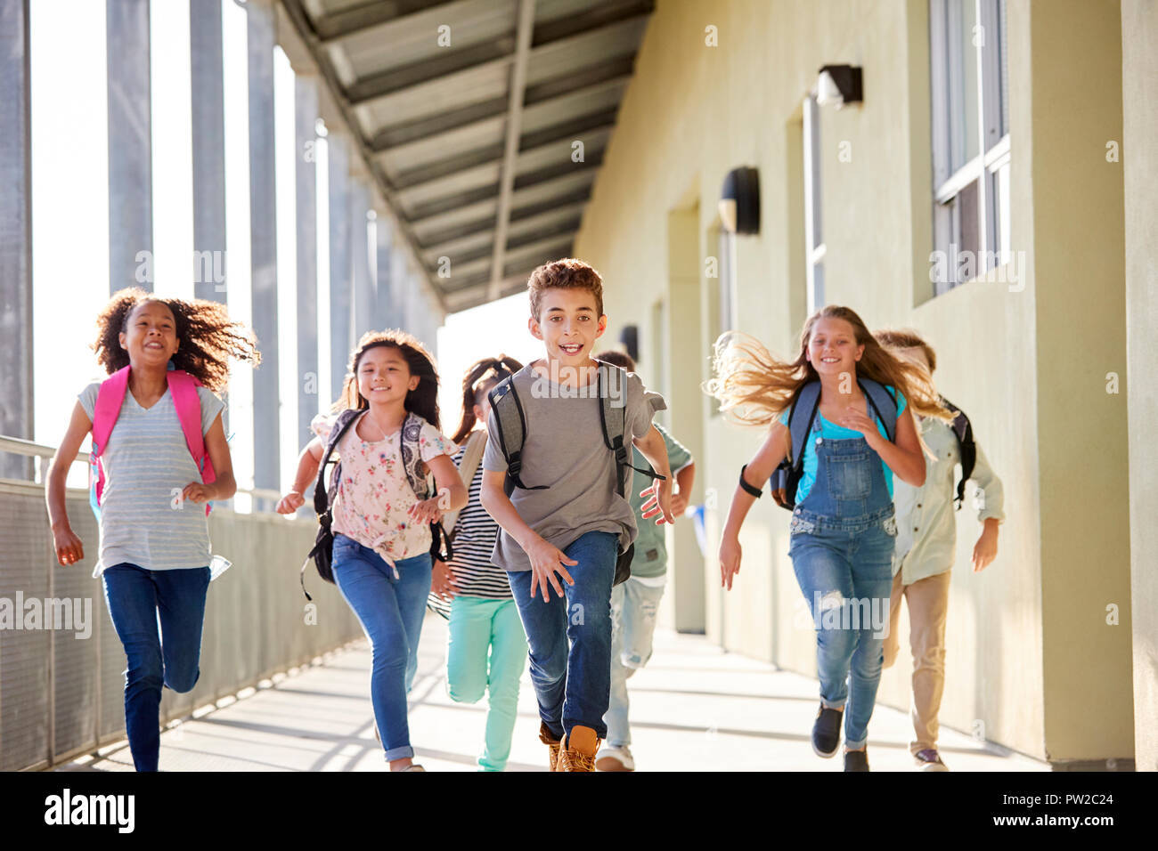 Kids running in elementary school corridor, close up Stock Photo - Alamy
