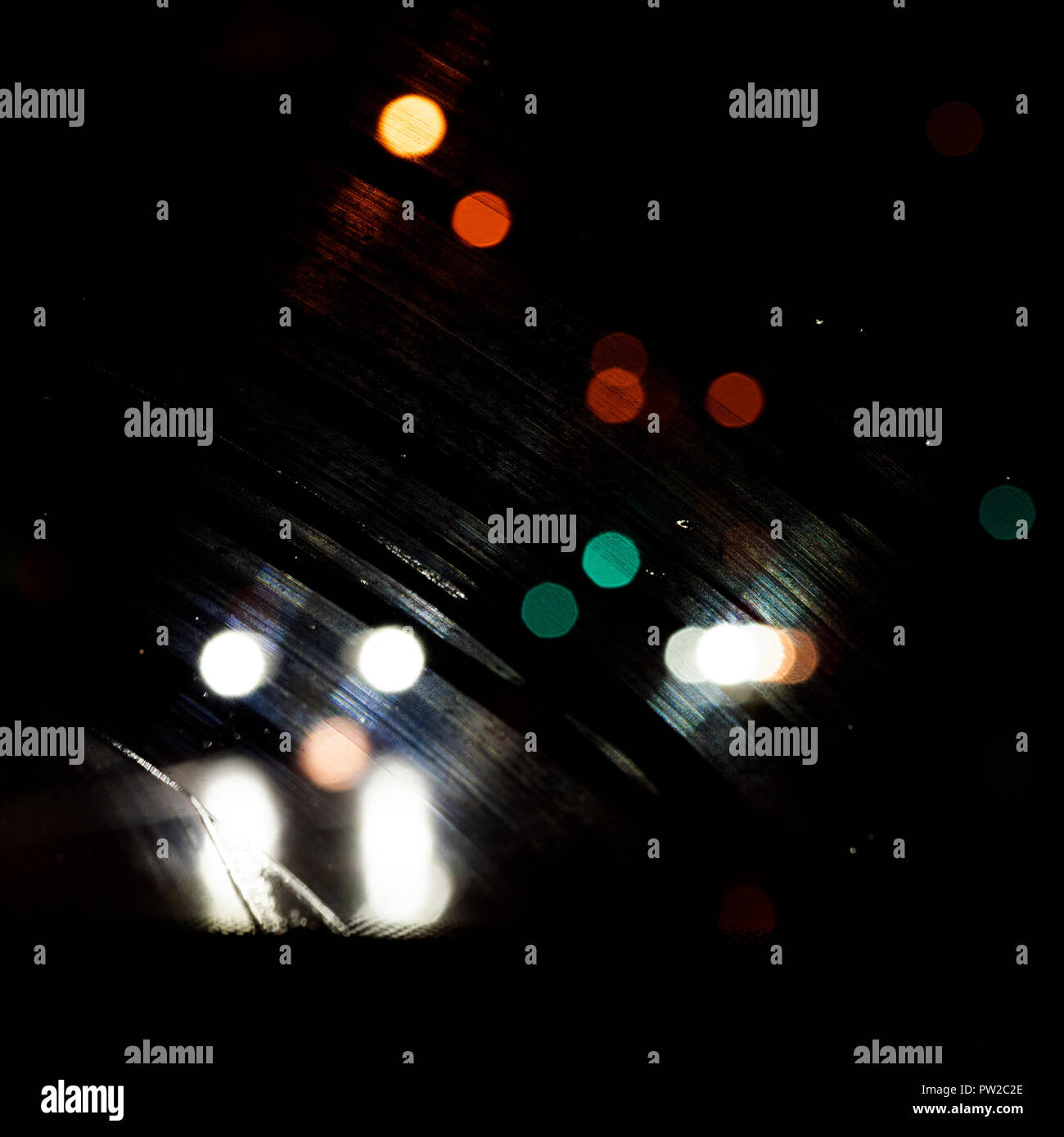 Blurred car lights on a wet street after the rain shot through the ...