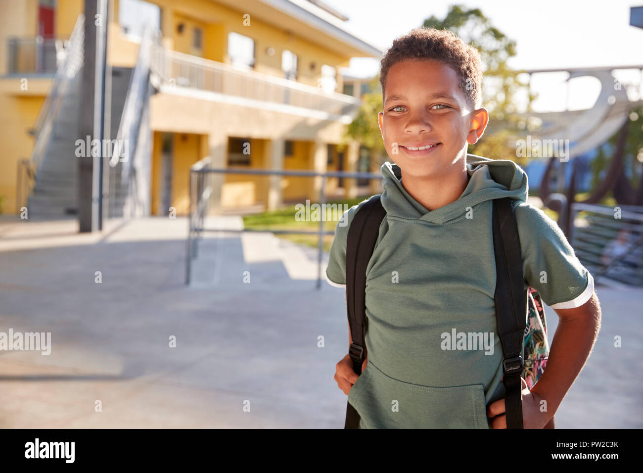 Portrait of smiling elementary school boy with his backpack Stock Photo ...