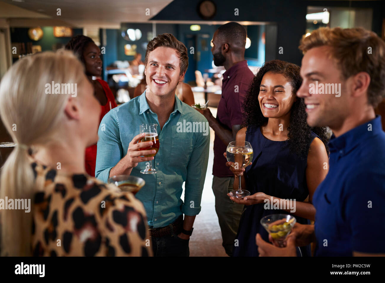 Group Of Young Friends Relaxing In Bar Together On Night Out Stock ...