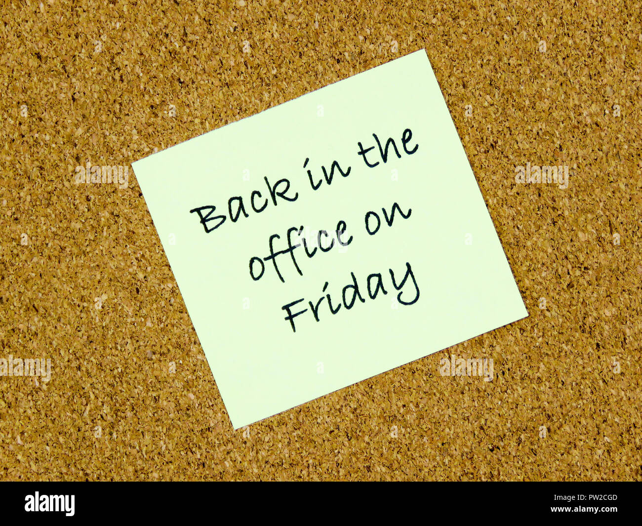 A yellow sticky note with back in the office on Friday written on it on ...